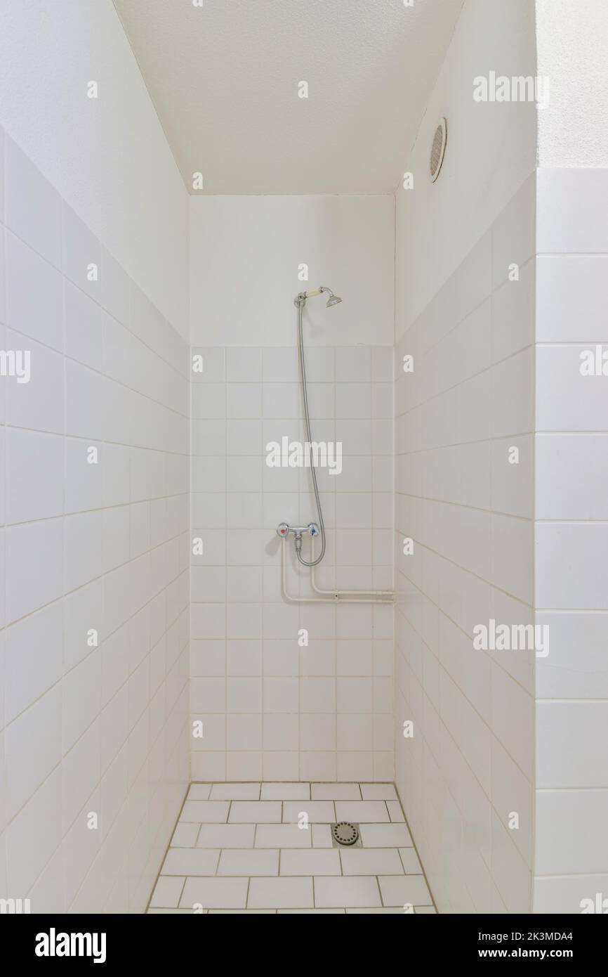 Interior of modern shower cabin with tiled walls and built in shelf and ...