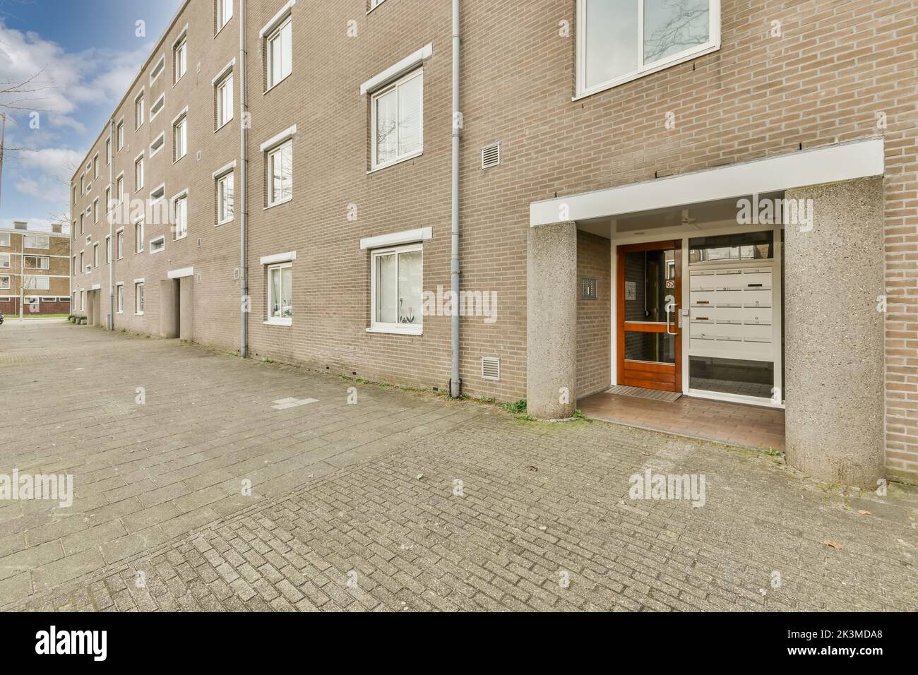 Facade of residential buildings located on street with paved paths in ...
