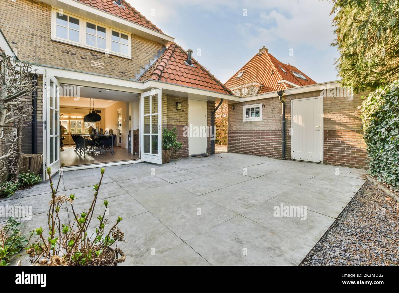 Backyard of a house with open windows into the house next to other ...