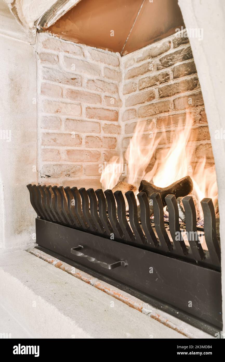 Side view of a lit indoor fireplace in a modern house Stock Photo - Alamy
