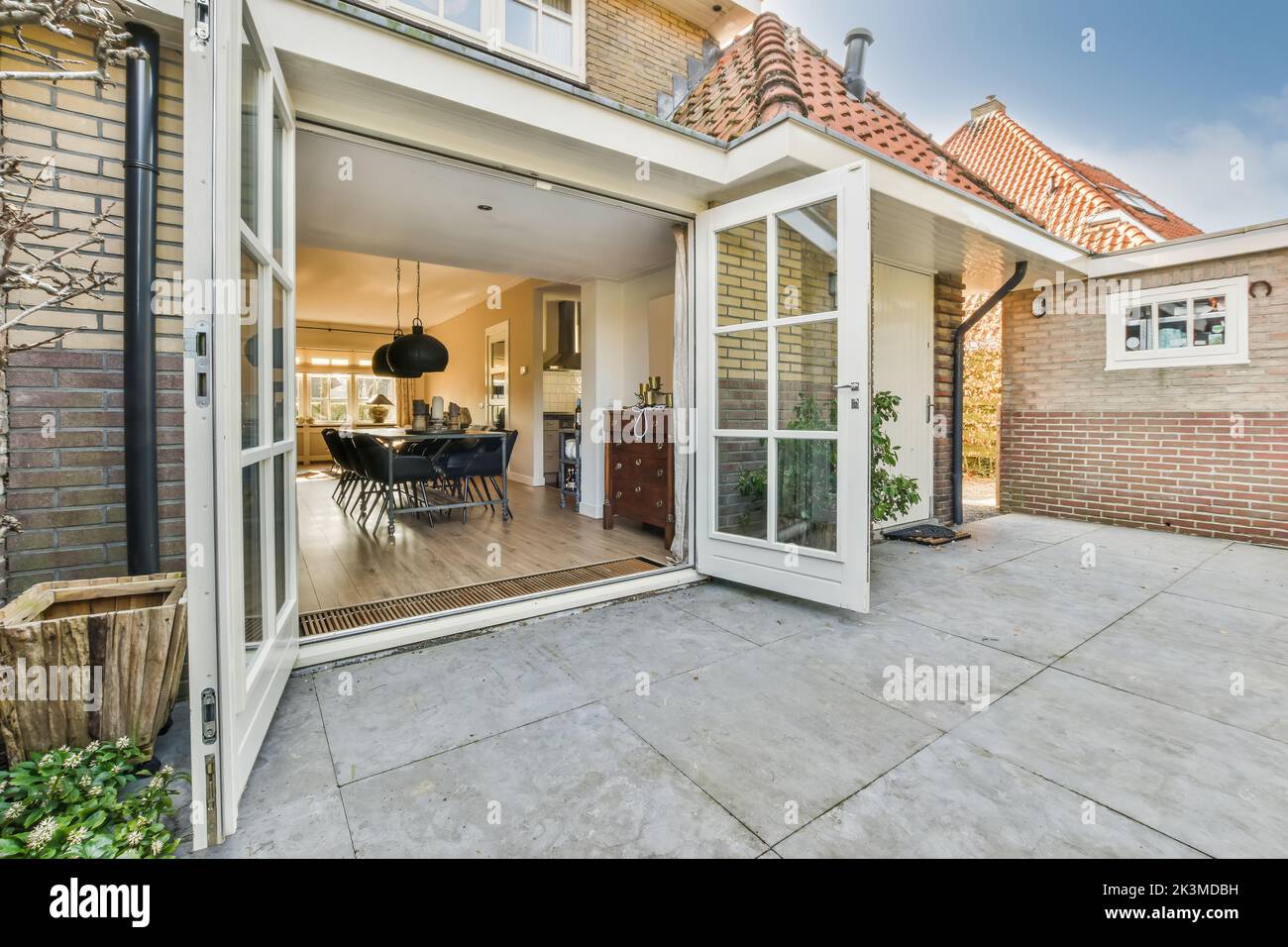 Backyard of a house with open windows into the house next to other ...