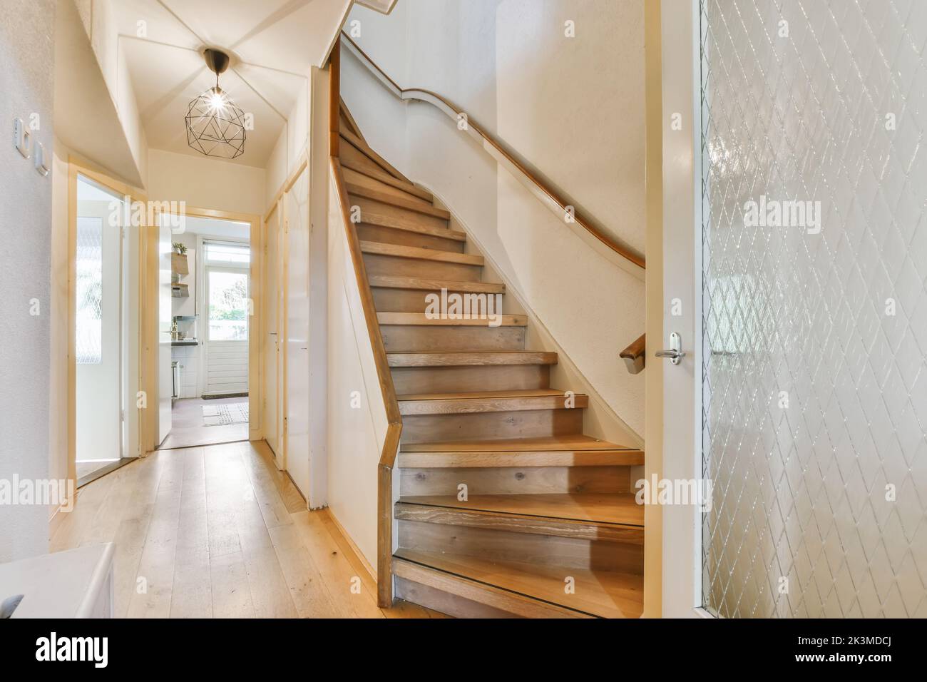 Interior of a house with stairs to an upper floor in a bright ...