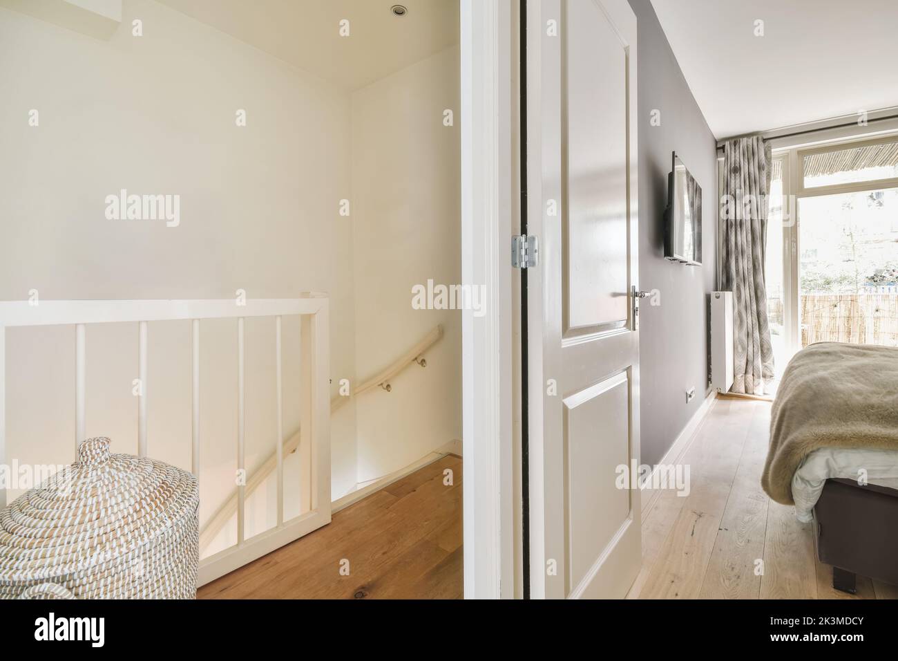 Interior passage way in bright modern house with parquet floor and ...