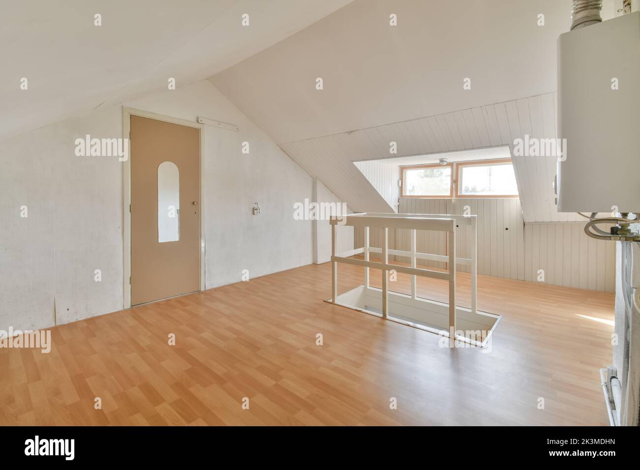 Attic empty modern room next to bright window and parquet floor with ...