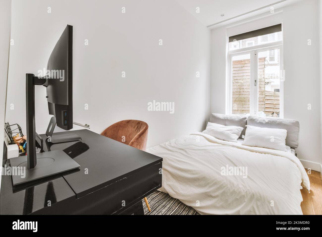 Interior of modern bedroom with comfortable bed and workspace with desk ...