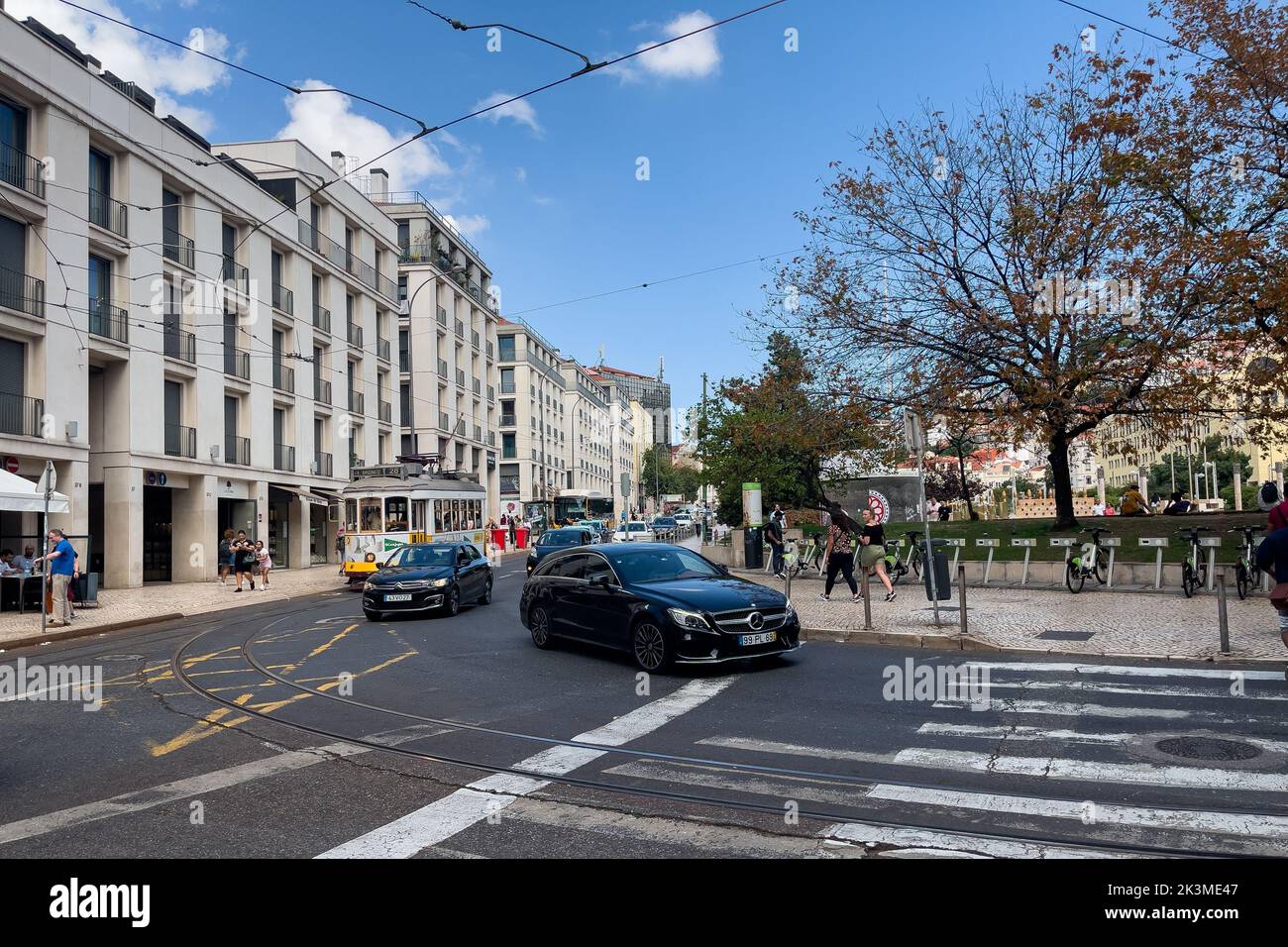 Cars driving past a retro tram Stock Photo - Alamy