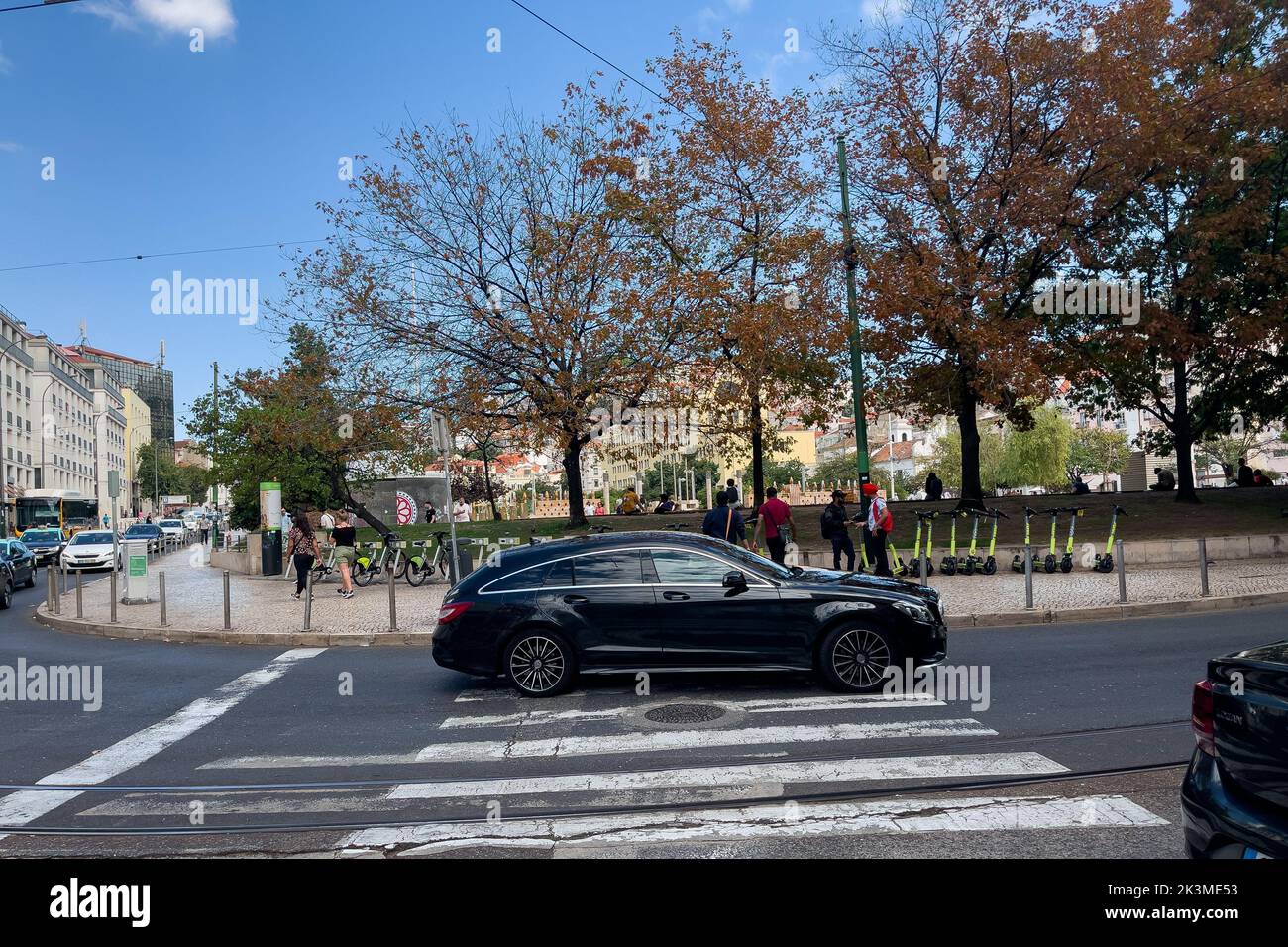 Cars driving past a retro tram Stock Photo - Alamy