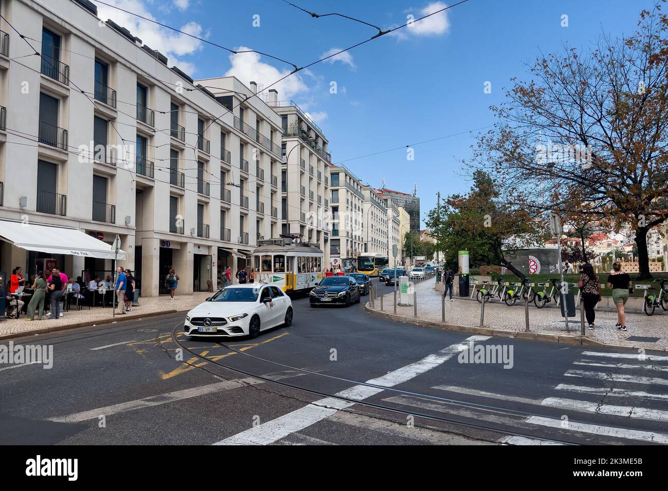 Cars driving past a retro tram Stock Photo - Alamy