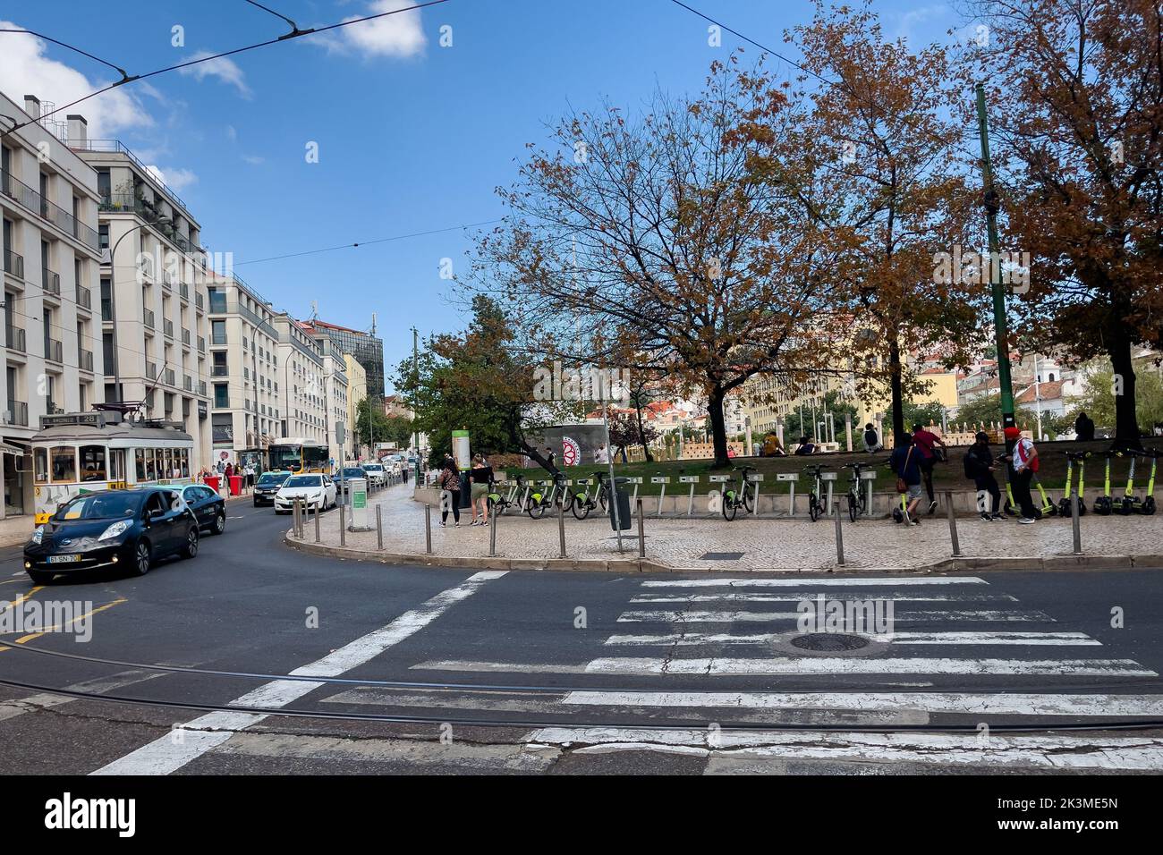 Cars driving past a retro tram Stock Photo - Alamy