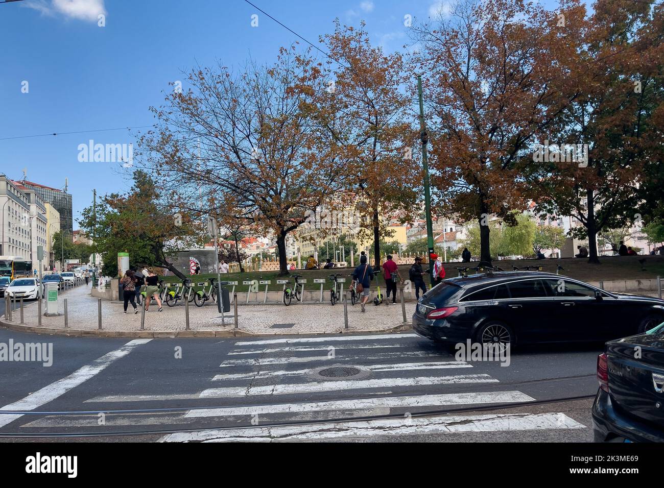 Cars driving past a retro tram Stock Photo - Alamy