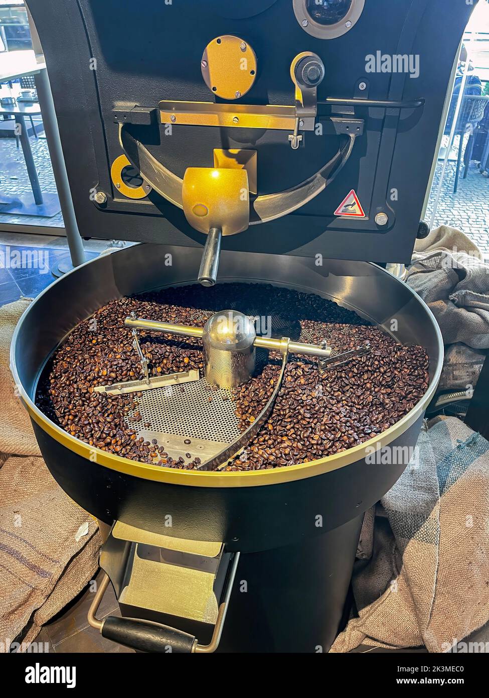 industrial coffee roaster machine with coffee beans in the the sieve ...