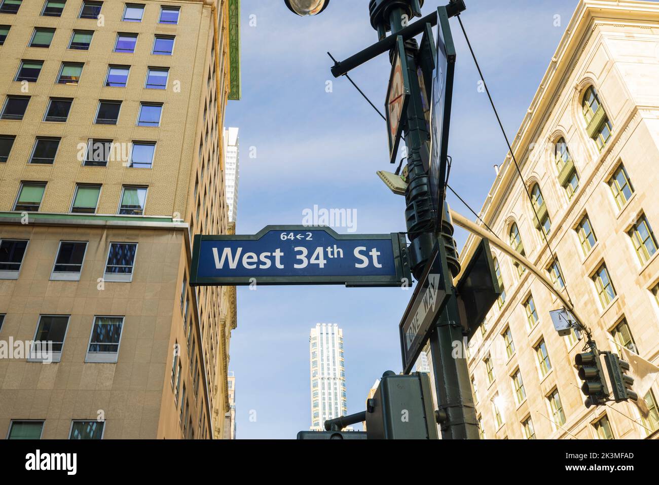 Beautiful cityscape view of buildings tops on blue sky background. Sign of West 34th Street. New ...