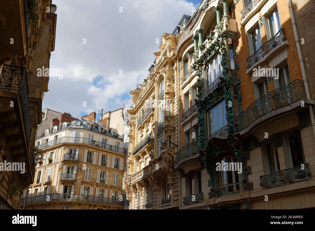 The facades of traditional French houses with typical balconies and ...