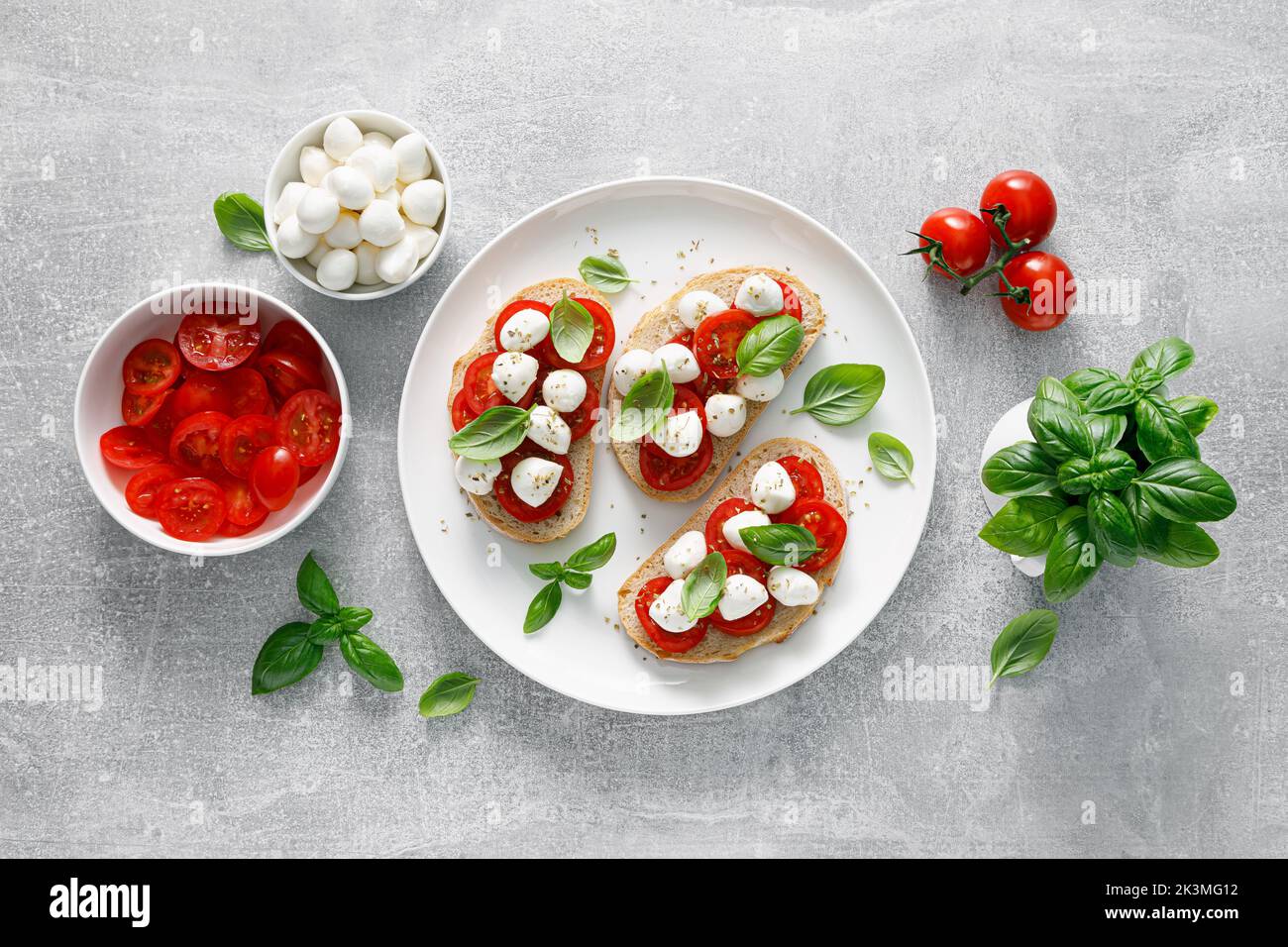 Caprese toasts with mini mozzarella cheese, cherry tomato and basil ...