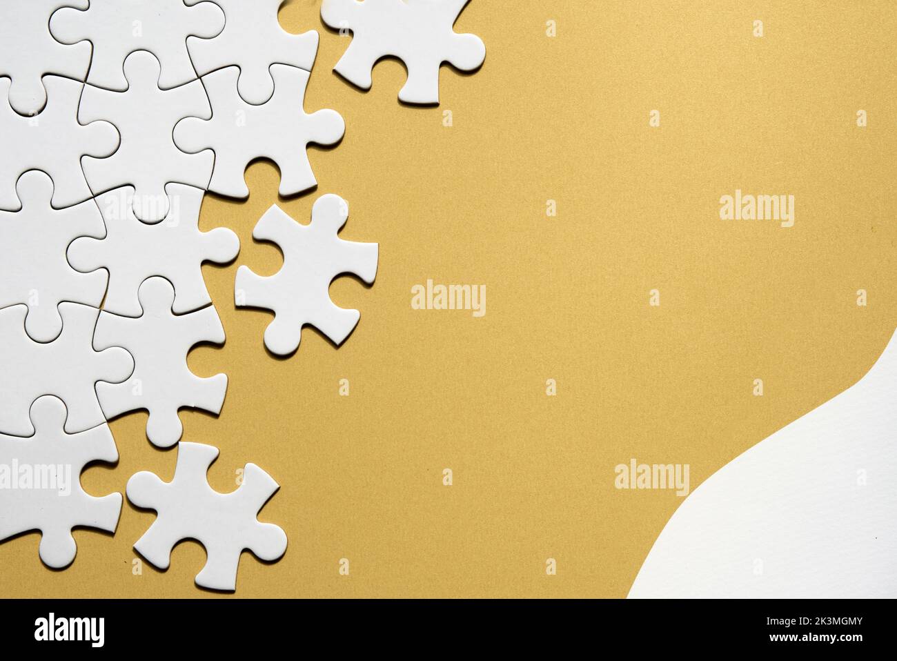 Jigsaw puzzle pieces half assembled and separate. Top view, flat lay on ...