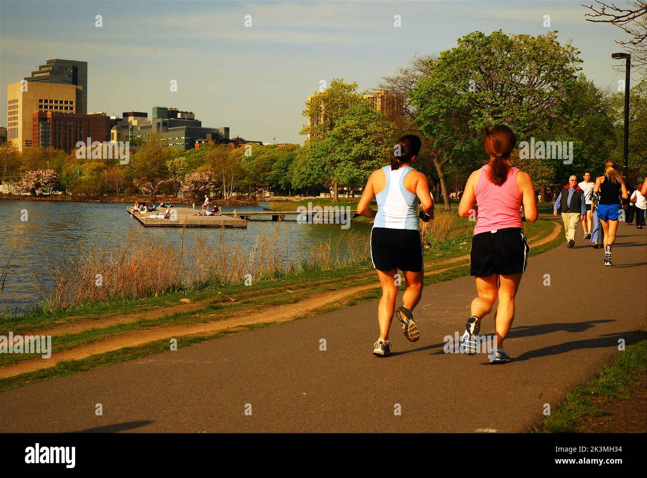 Two adult women friends jog along the Charles River Esplanade, getting ...