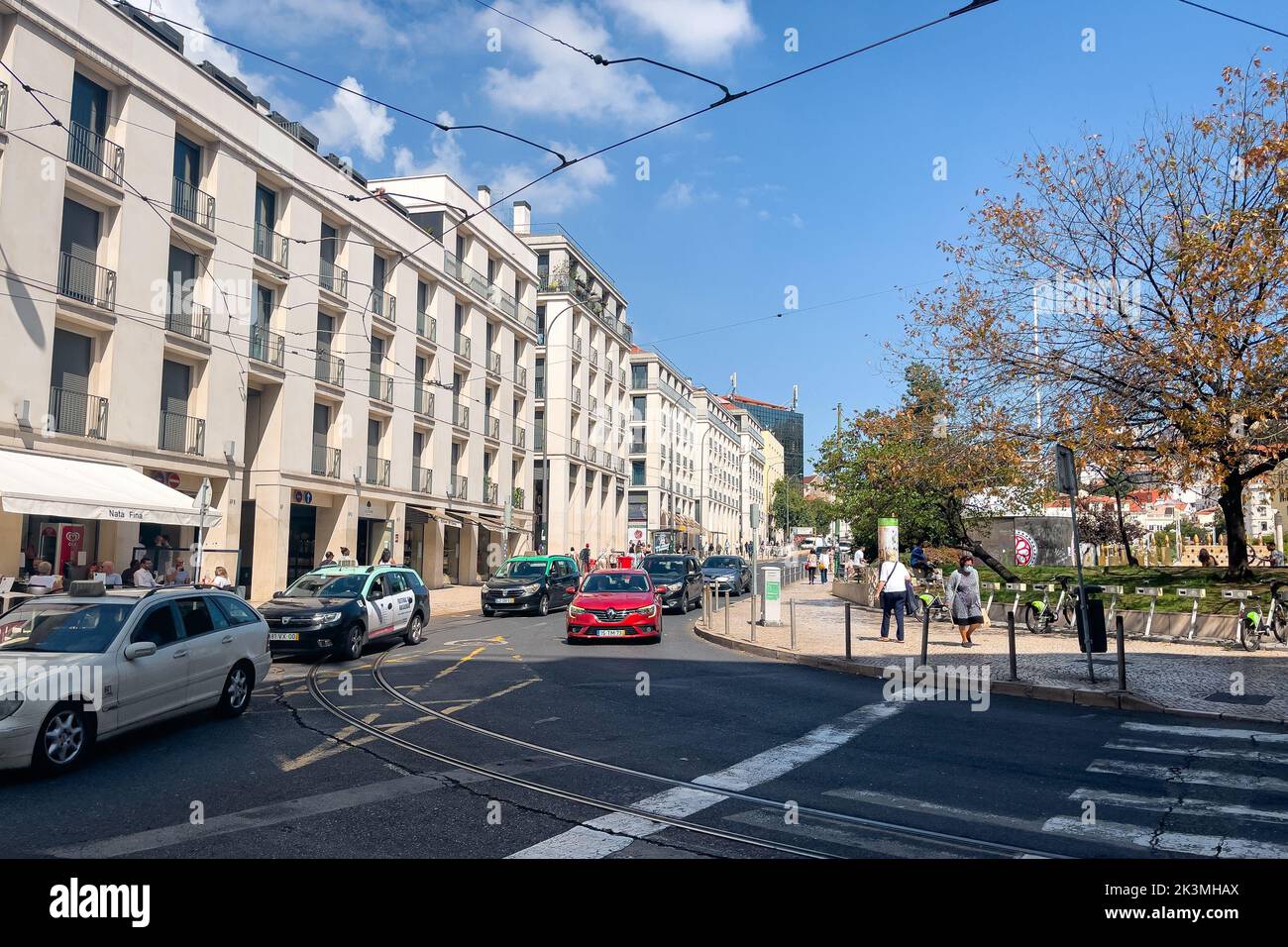 Cars driving past a retro tram Stock Photo - Alamy