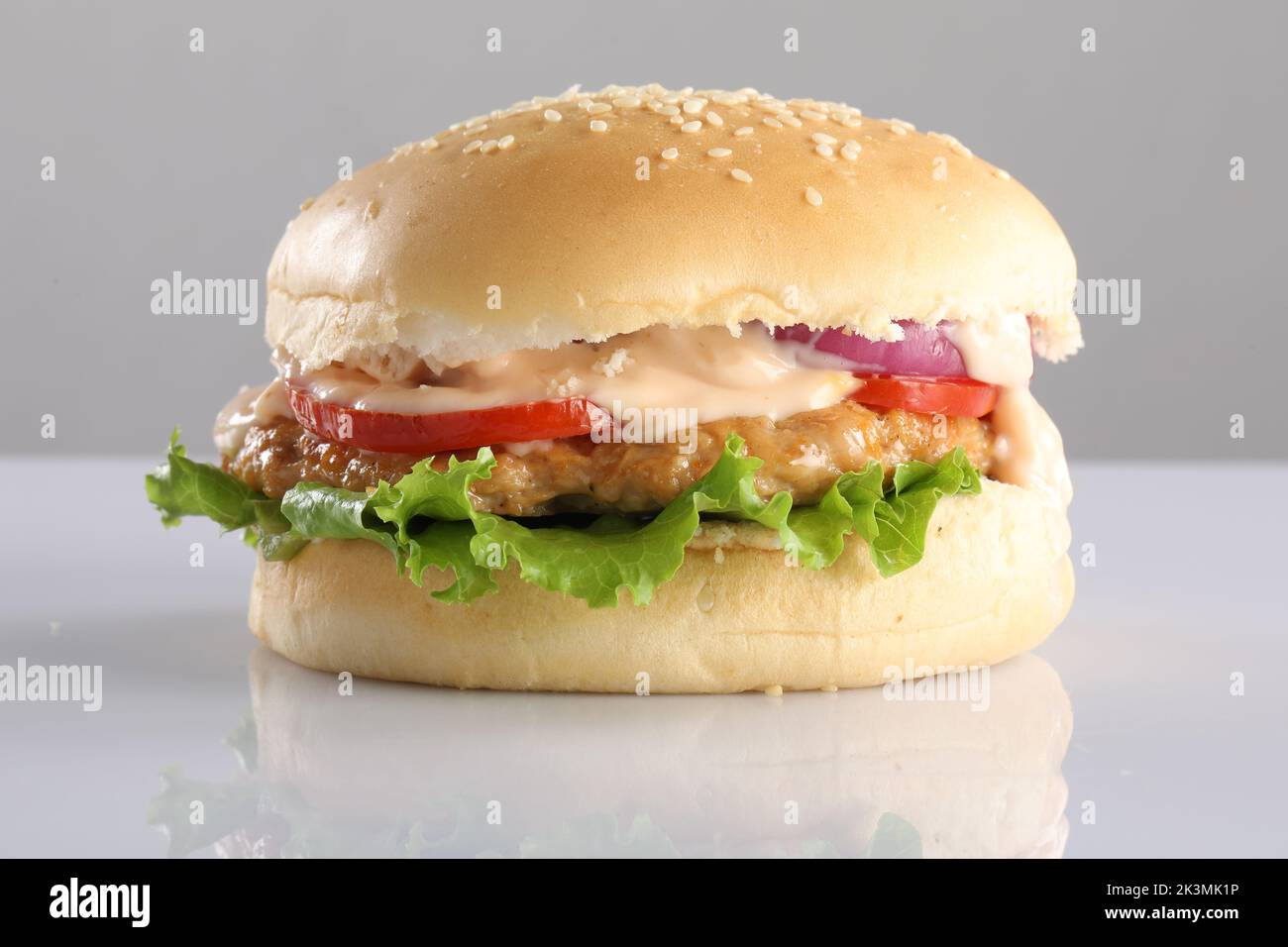 CRISPY CHEESY CHICKEN PATTY BURGER ON WHITE background Stock Photo - Alamy