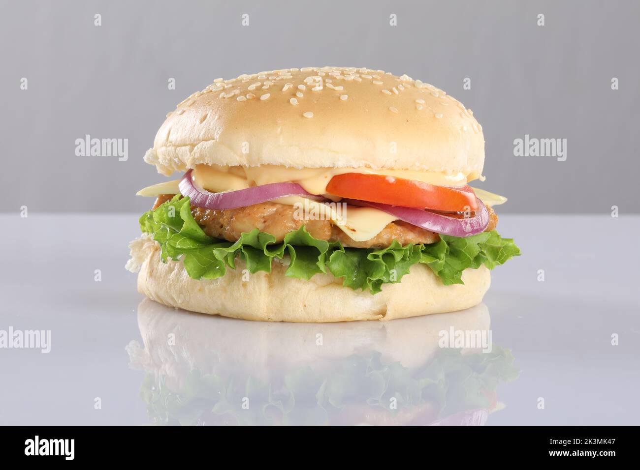 CRISPY CHEESY CHICKEN PATTY BURGER ON WHITE background Stock Photo - Alamy