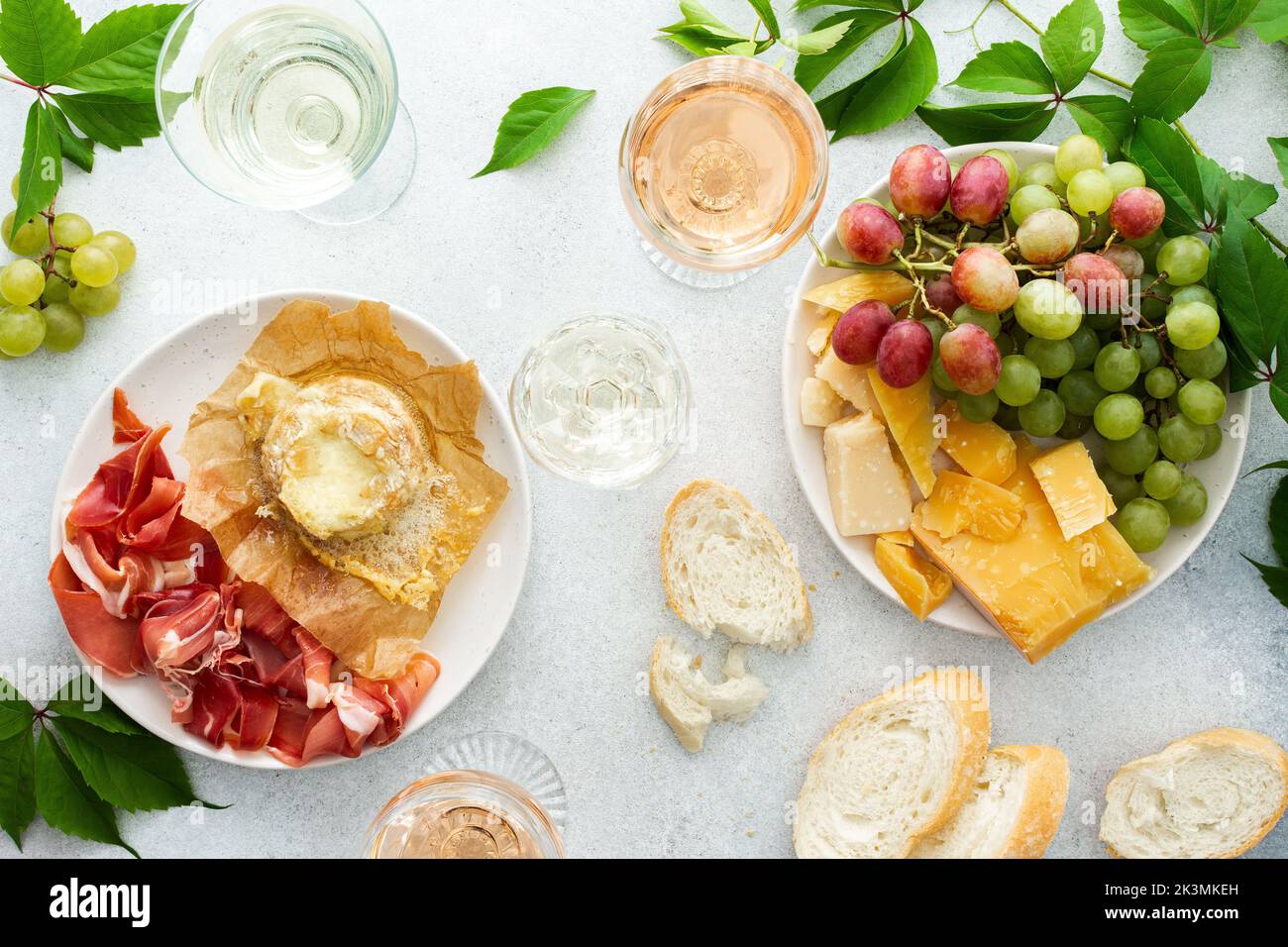 Top view of table with rose and white wine in glasses, plates with ...