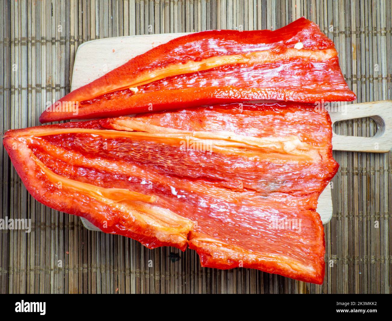 The pulp of long red sweet pepper on the kitchen table. Cut pepper ...