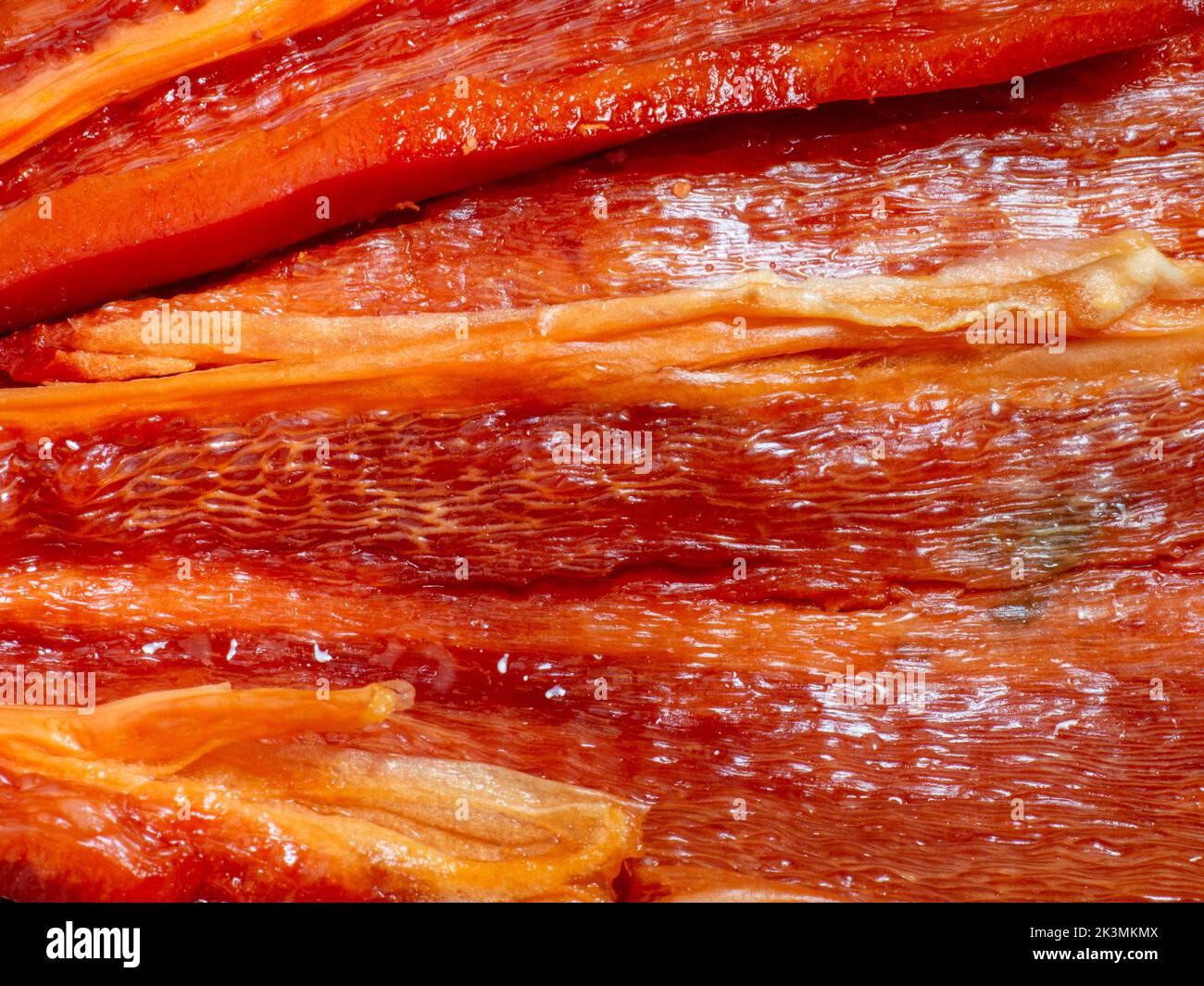 The pulp of long red sweet pepper on the kitchen table. Cut pepper ...