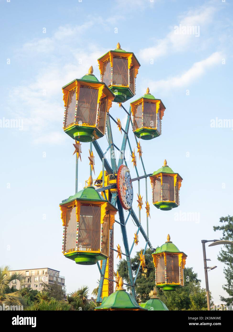 A small Ferris wheel in the park. A bright attraction for children ...