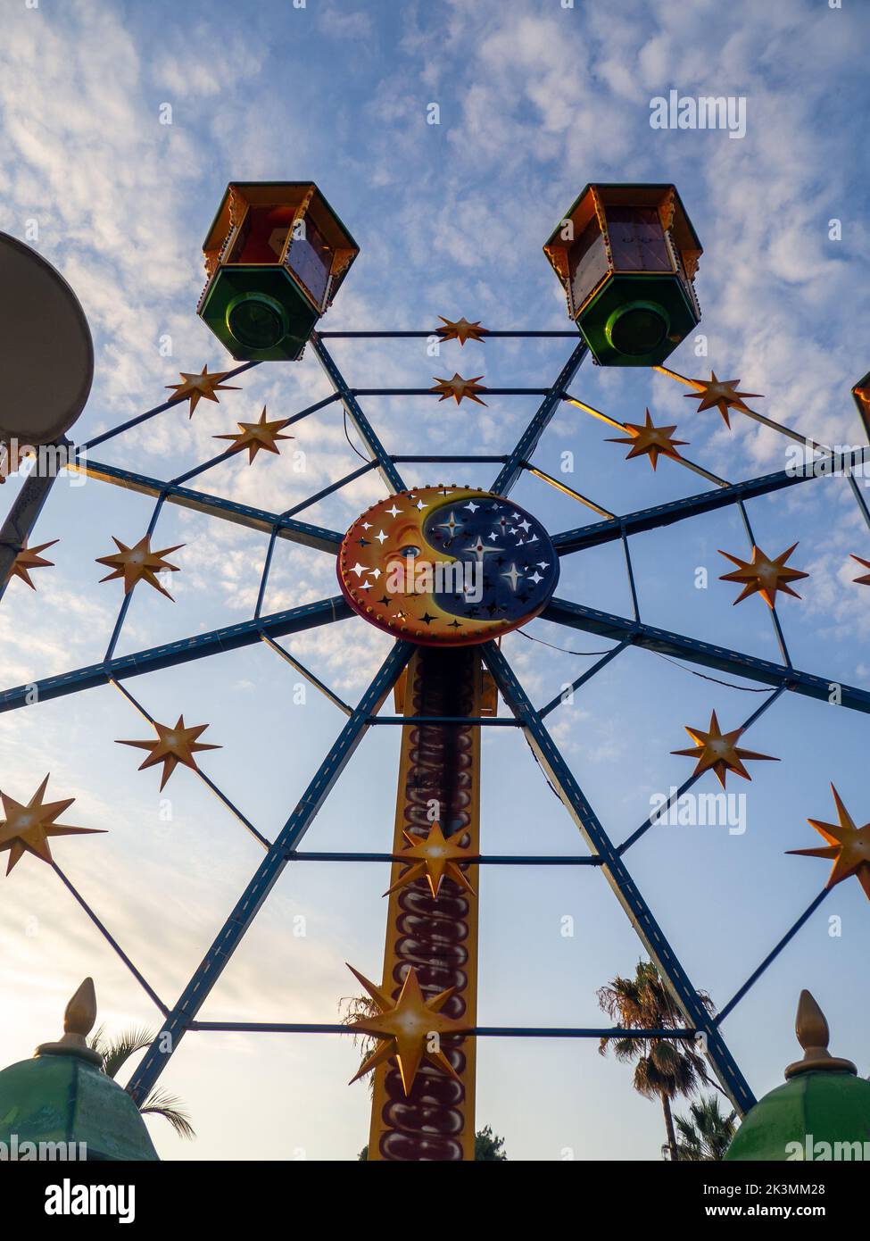 A small Ferris wheel in the park. A bright attraction for children ...