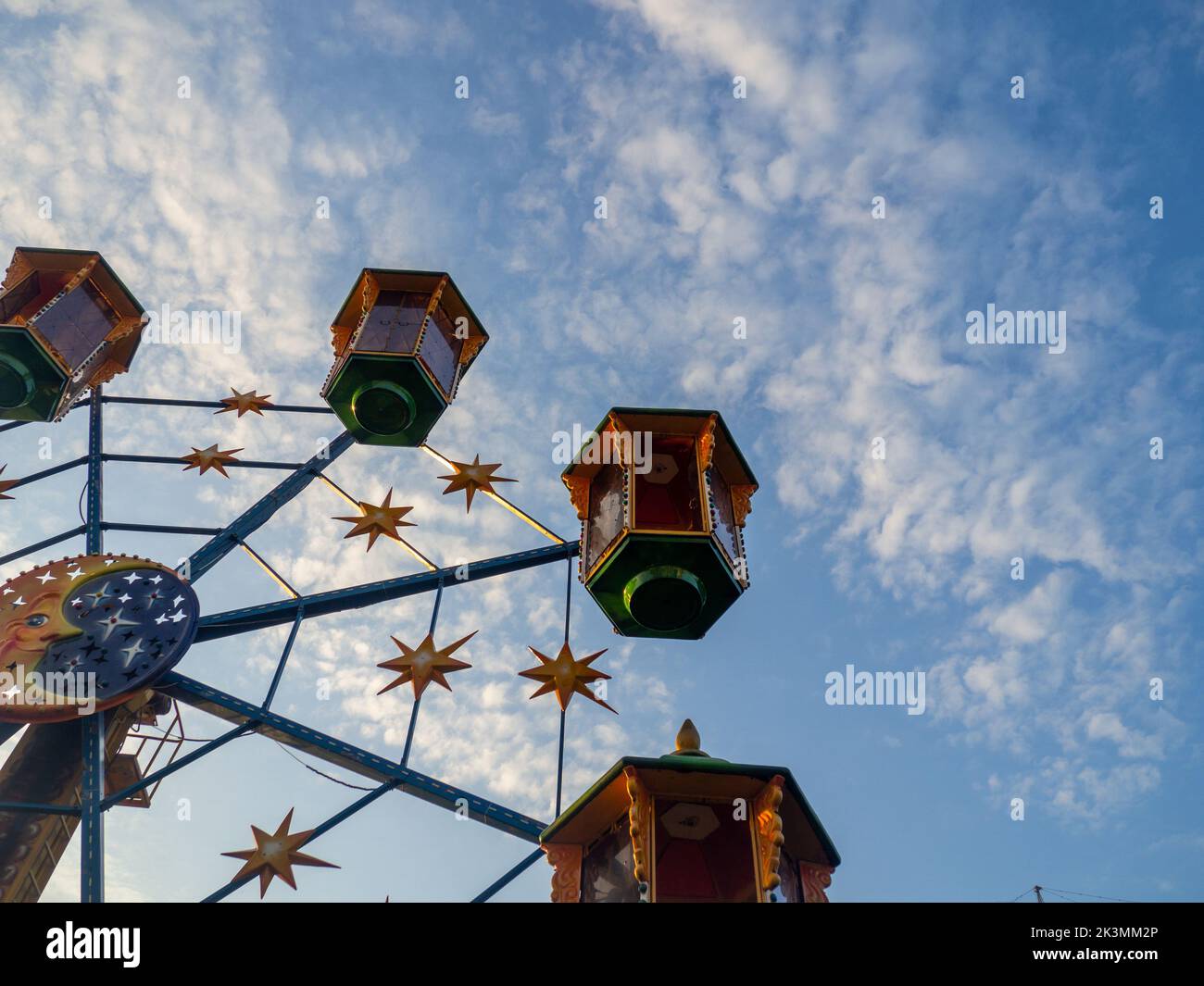 A small Ferris wheel in the park. A bright attraction for children ...