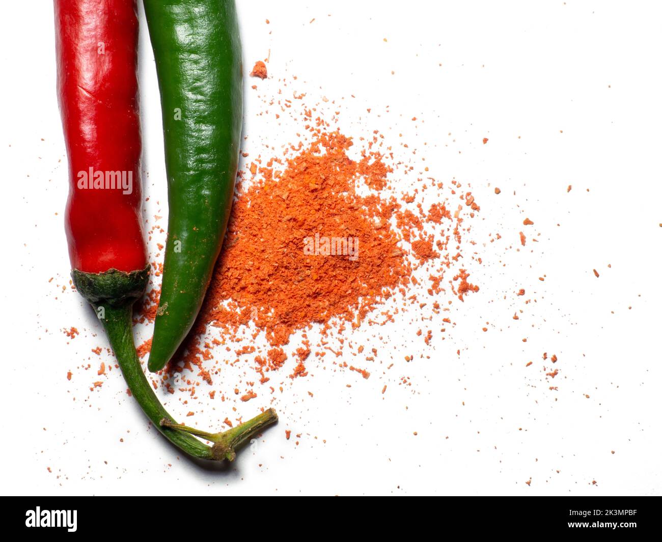 The green pepper and ground red pepper are isolated. Spicy pepper on a ...