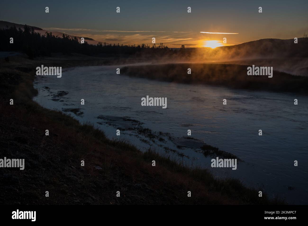 Golden sunrise along the Madison River in Yellowstone National Park ...