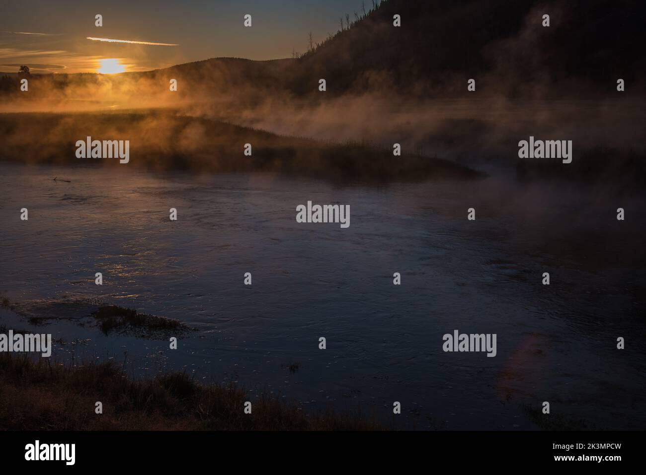 Golden sunrise along the Madison River in Yellowstone National Park ...