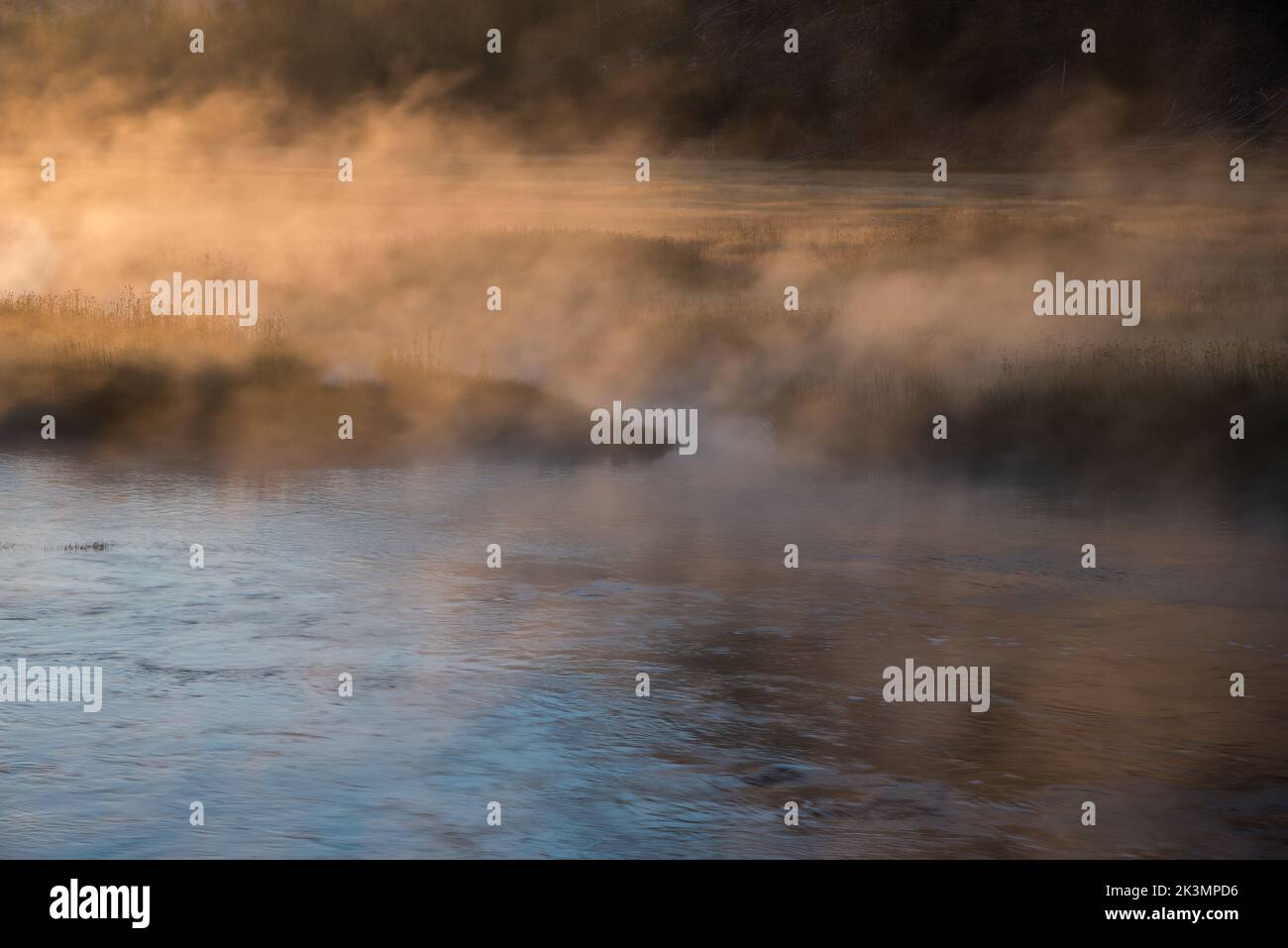 Soft mist rising from Madison River in early morning sunlight. Colder ...