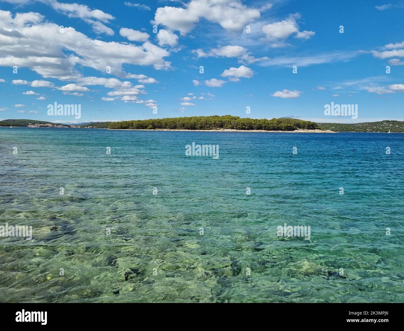 A scenic view of the crystal clear sea on a sunny day in Zmajan ...