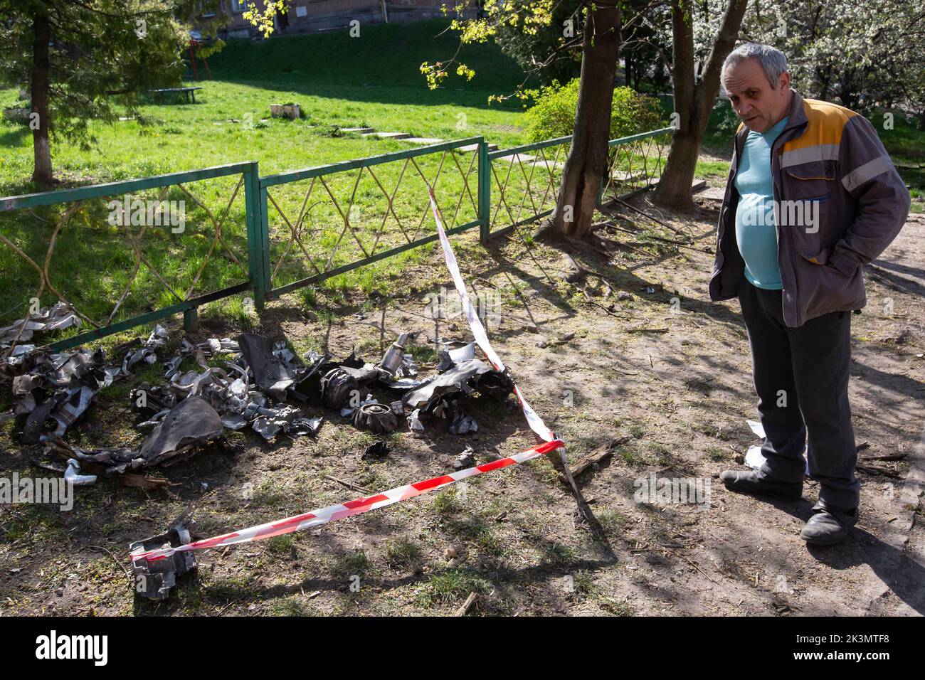 A man looks at a fragment of Russian rocket at the site of a military ...