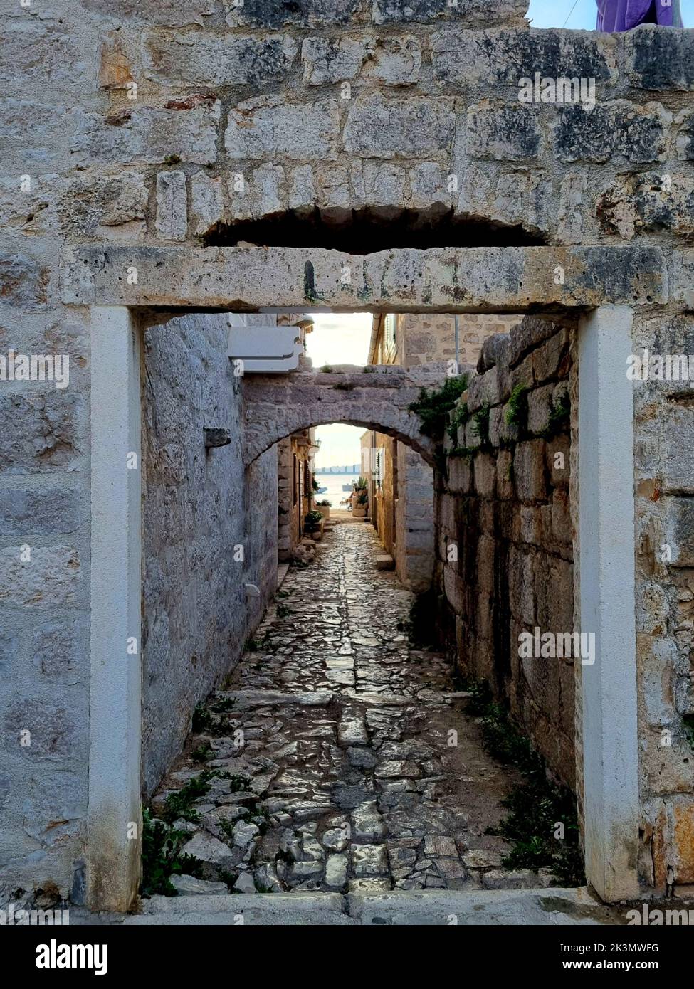 A vertical shot of inside of an old stone building with a narrow road ...