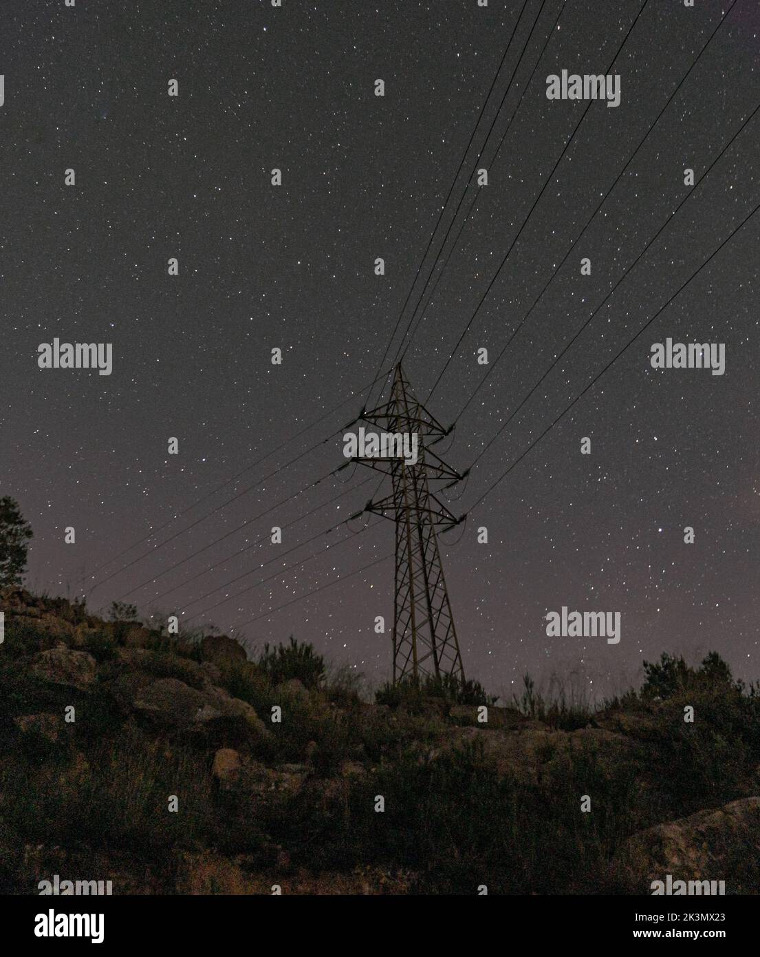 The vertical view of an electricity column over the hill under the ...