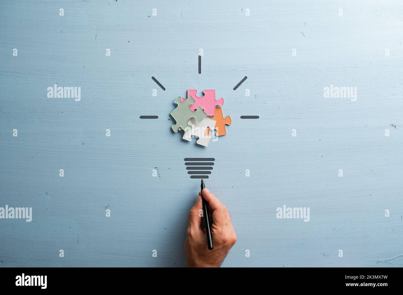 Light bulb made of colorful puzzle pieces and stem and rays cut into ...