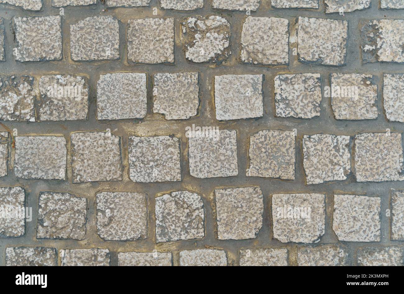 The texture of the stone pavement. Granite square cobblestone pavement ...
