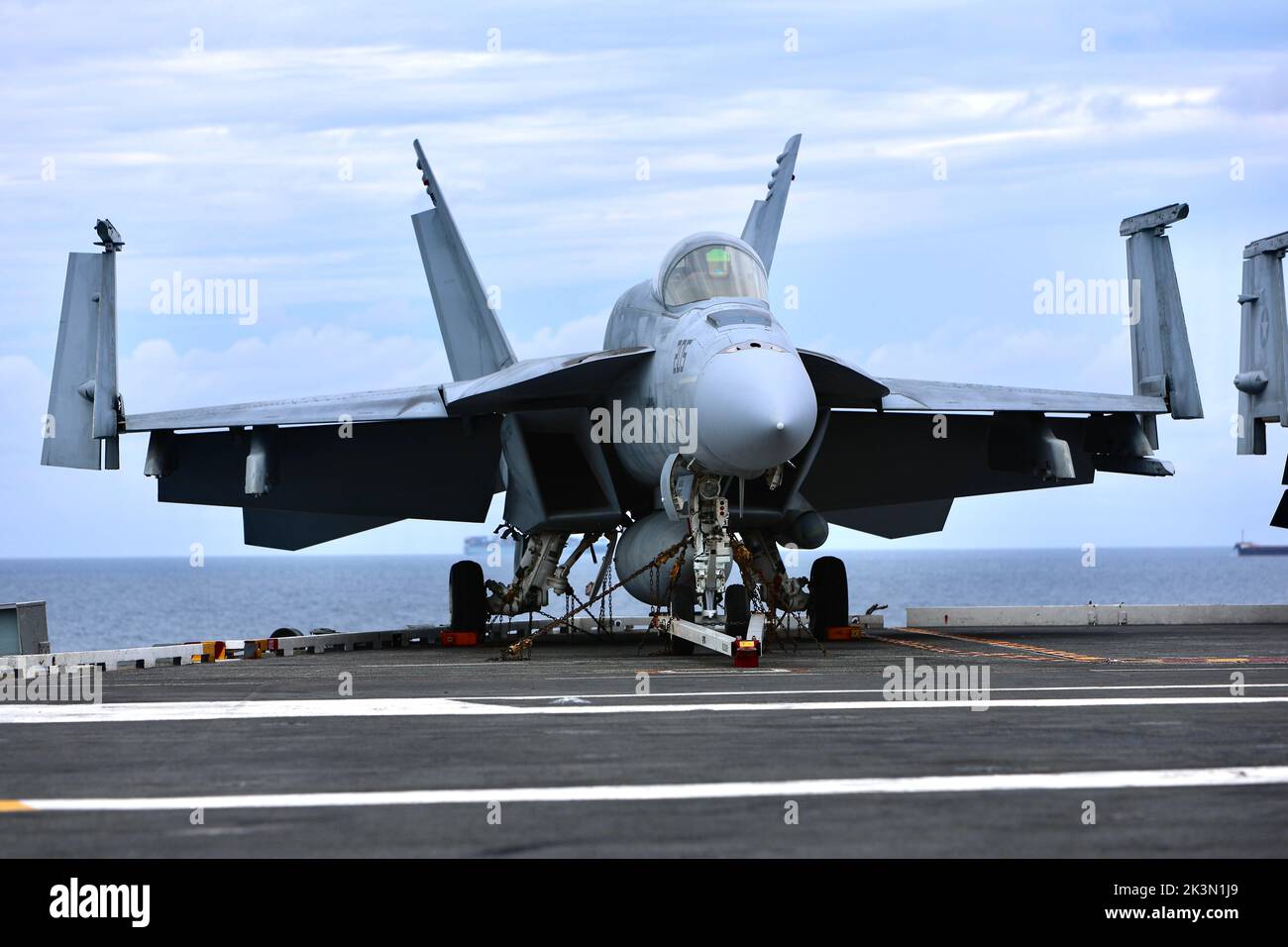 An F/A-18 Hornet sits on the deck of the USS Ronald Reagan (CVN 76 ...