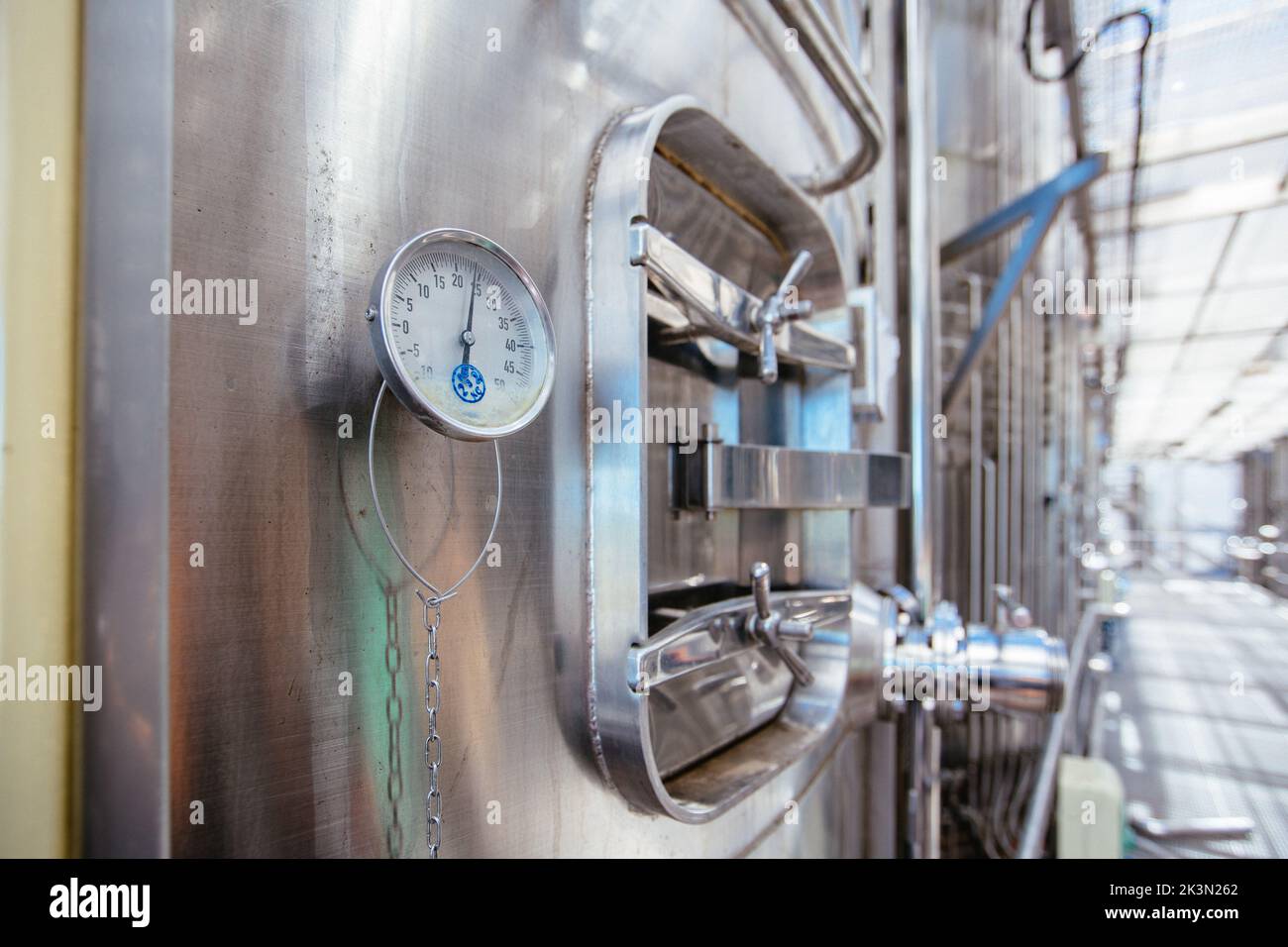 Thermometer or pressure gauge on fermentation vat in modern winery ...