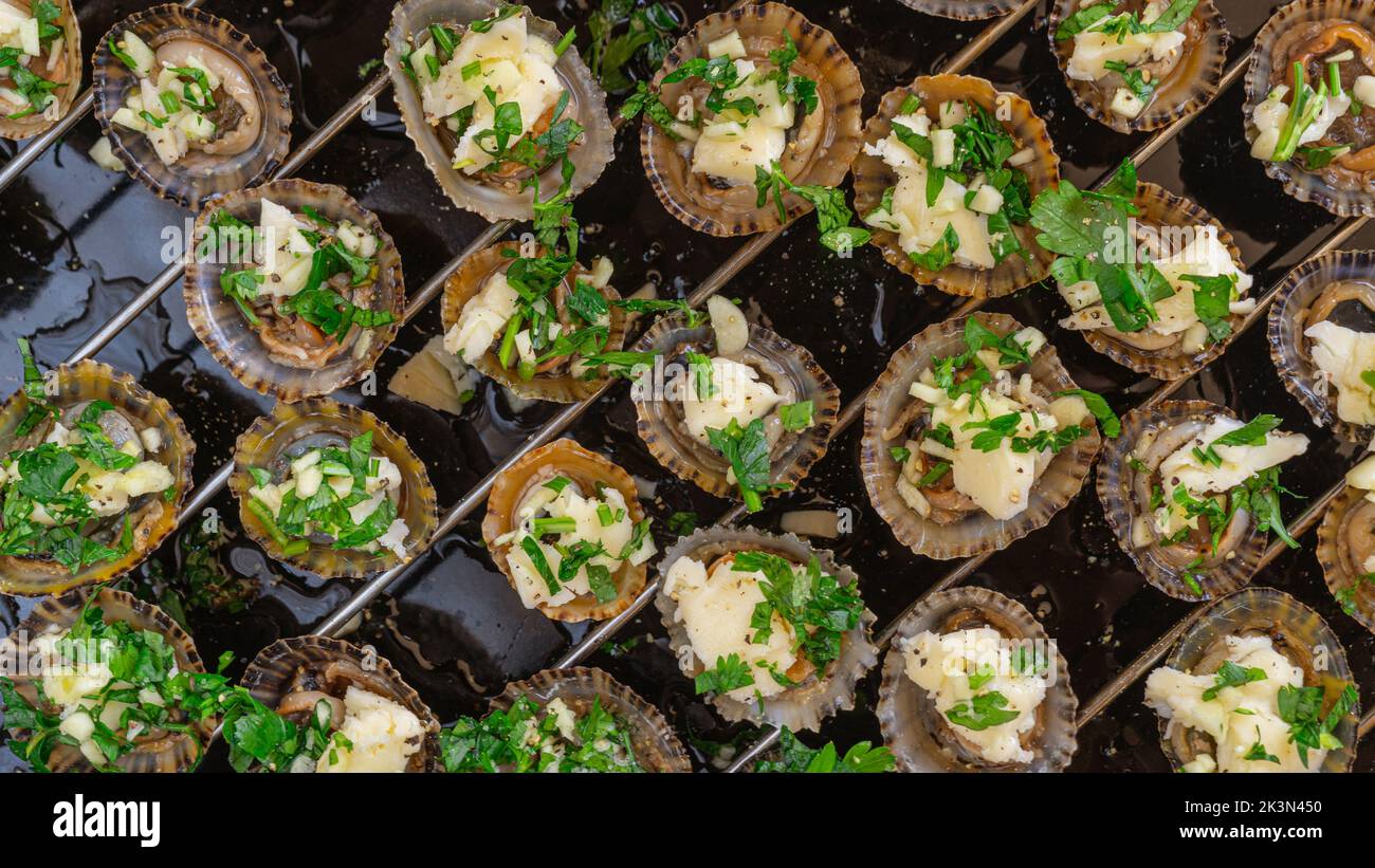 Limpets molluscs with garlic parsley butter Stock Photo - Alamy