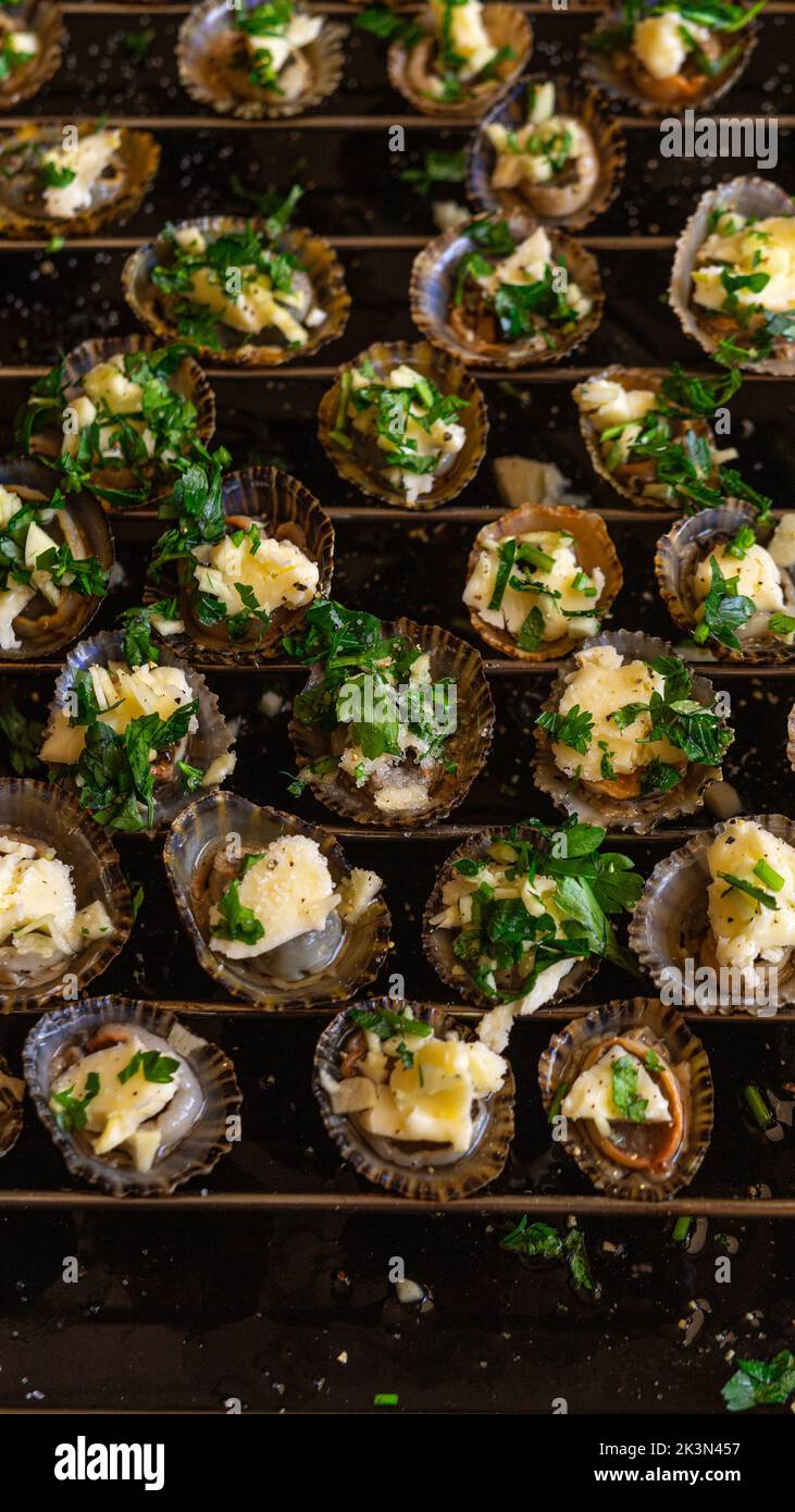 Limpets molluscs with garlic parsley butter Stock Photo - Alamy