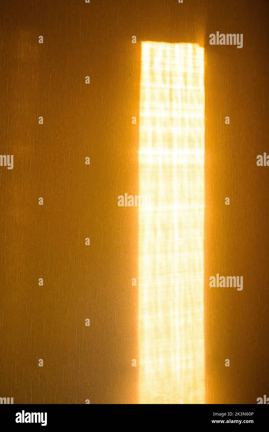 Sunbeam on yellow wall of house. Surface texture with sun glare ...