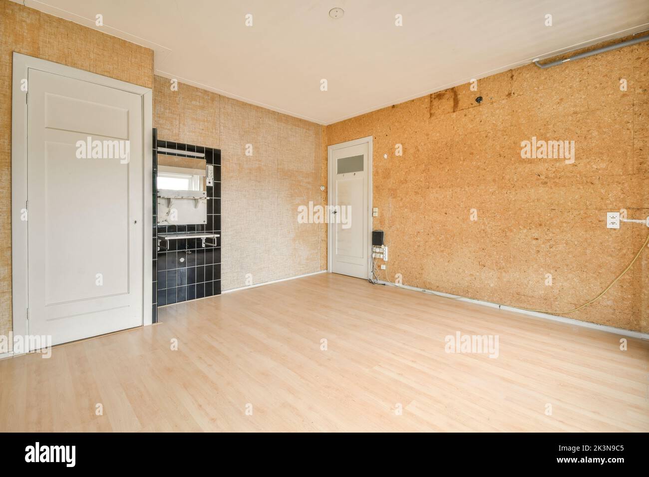 Plastic window and radiator on white wall in empty light room at home ...