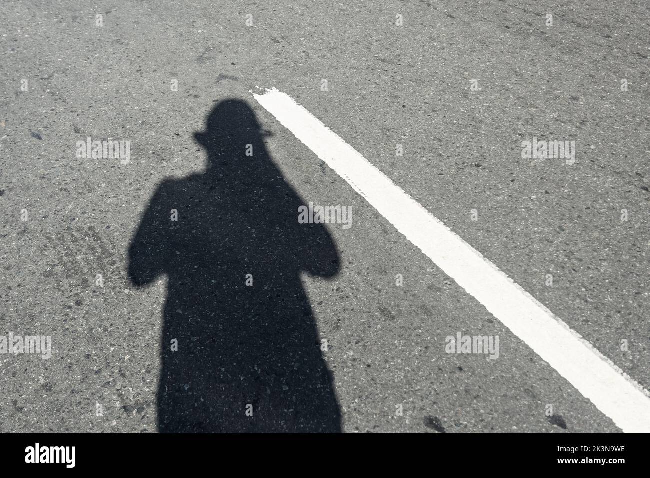 Street, asphalt, white strip and the photographers shadow. Salvador ...