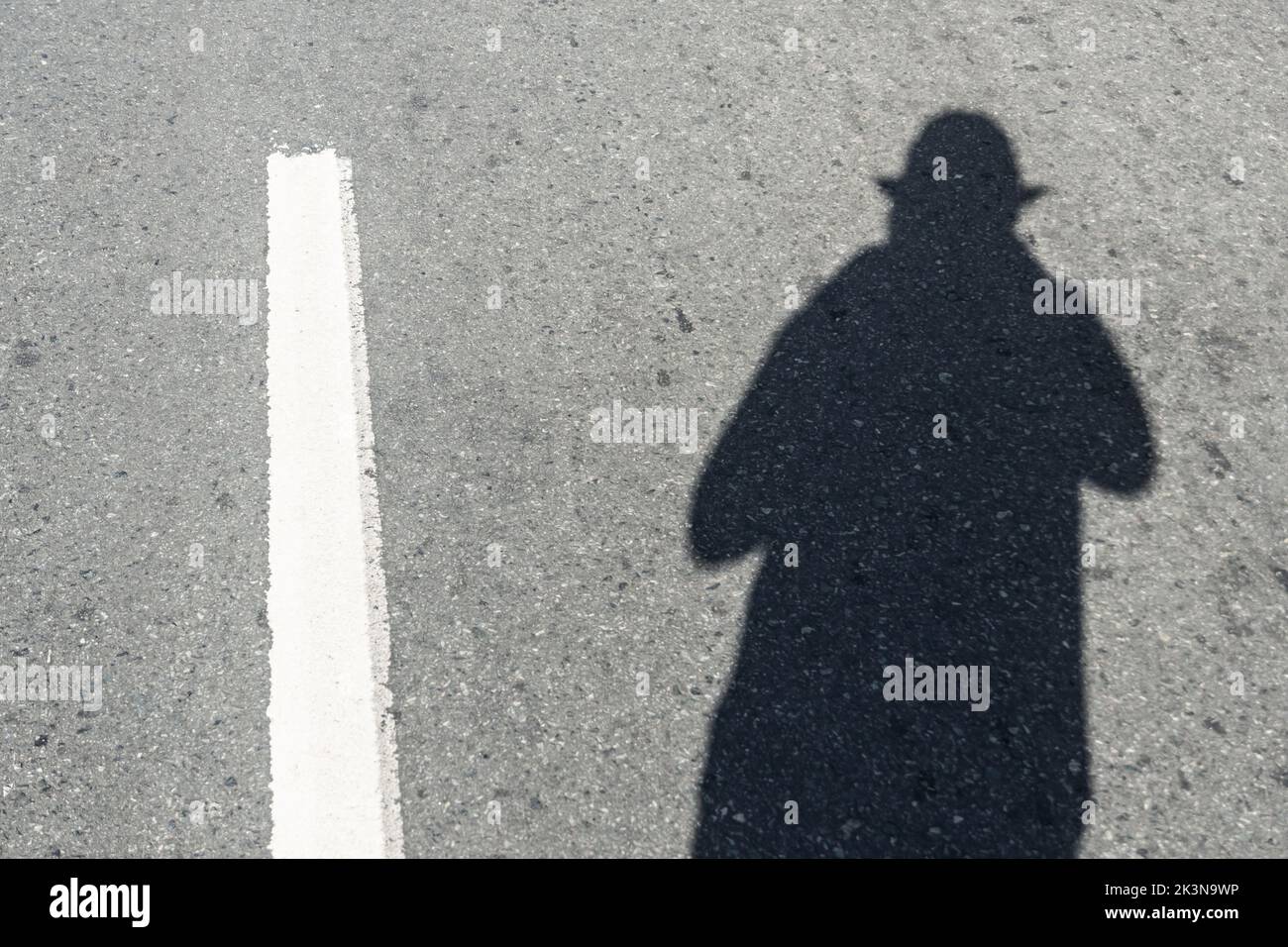 Street, asphalt, white strip and the photographers shadow. Salvador ...