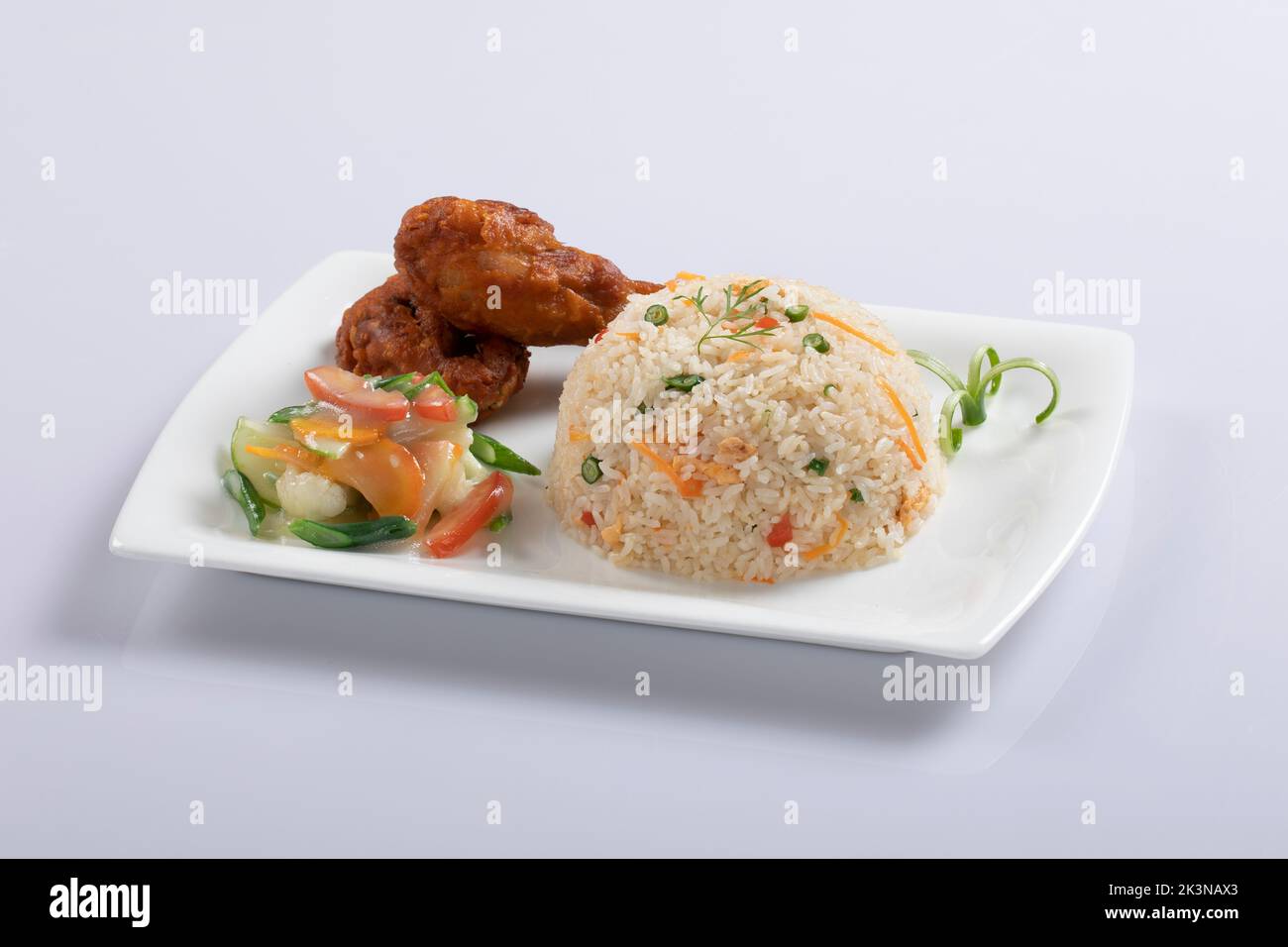 Schezwan Chicken Fried Rice in white bowl isolated on white background ...