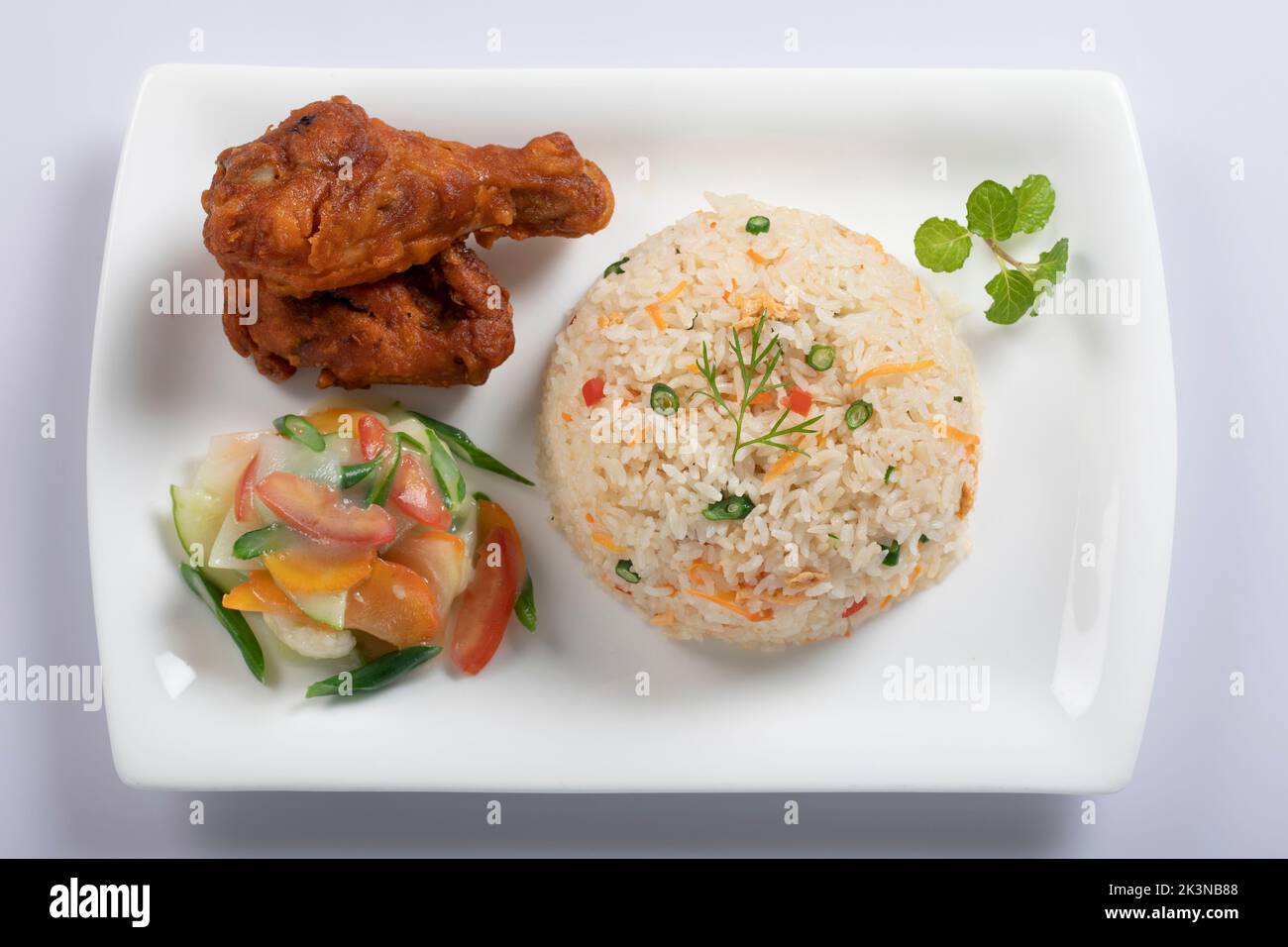 Schezwan Chicken Fried Rice in white bowl isolated on white background ...