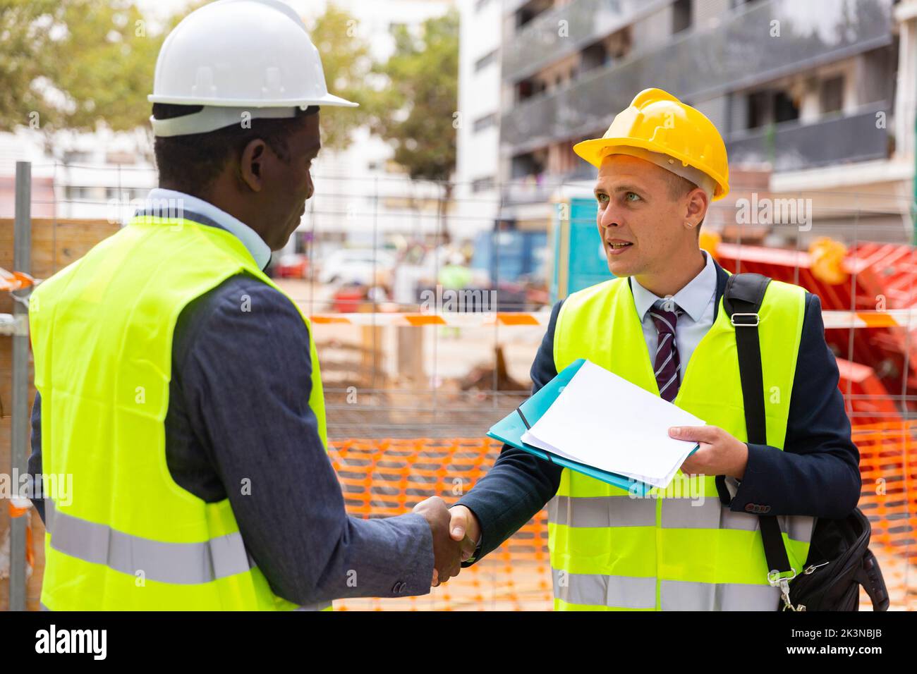 Two successful civil engineers exchange a friendly handshake Stock ...